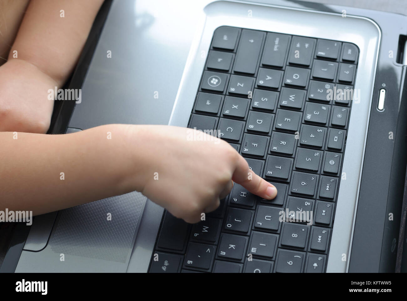 Children's hands and laptop. Finger presses the button keyboard Stock ...