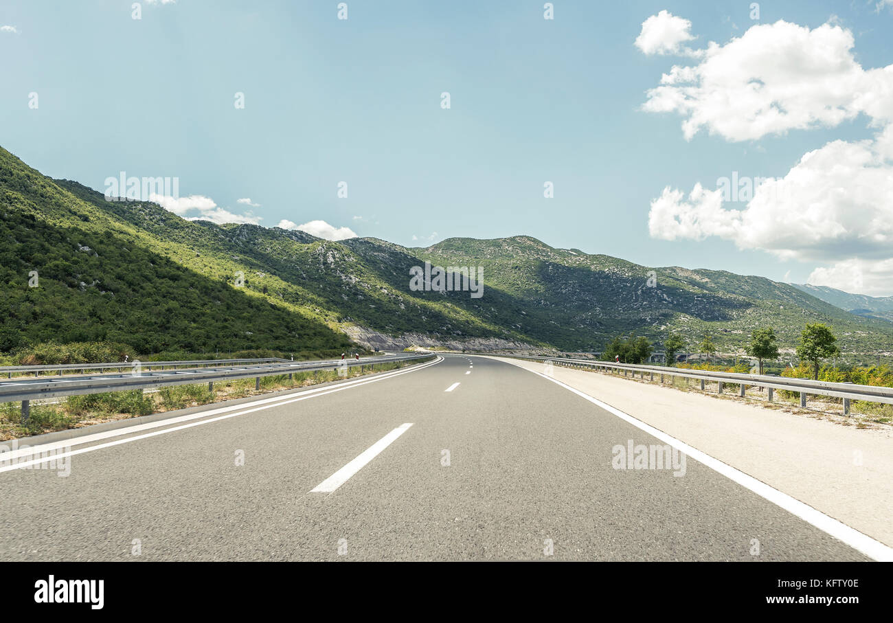 High-speed country road among the mountains Stock Photo - Alamy