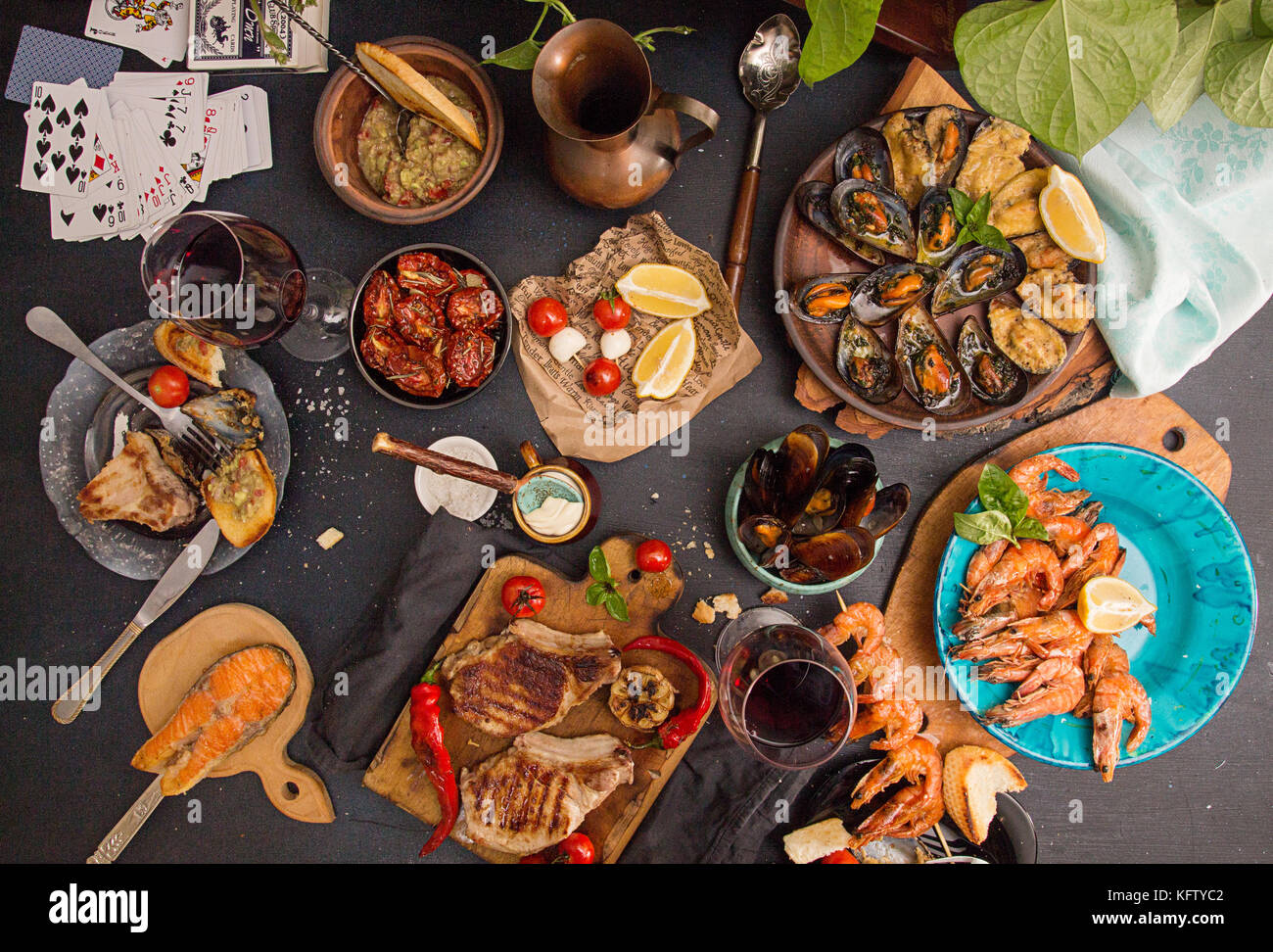 Overhead of dinner table. Assorted delicious grilled barbecue meat and ...