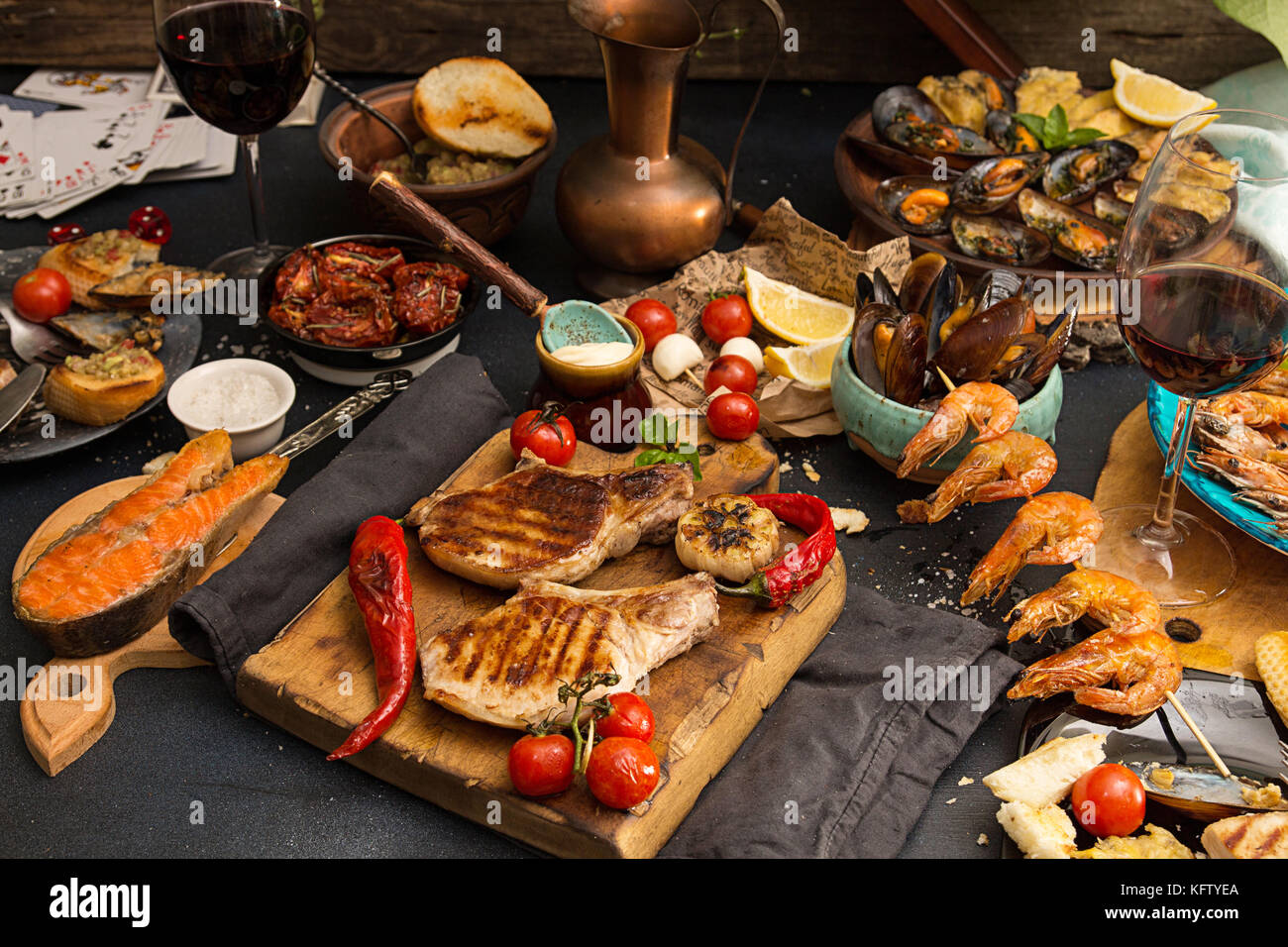 Overhead of dinner table. Assorted delicious grilled barbecue meat and ...