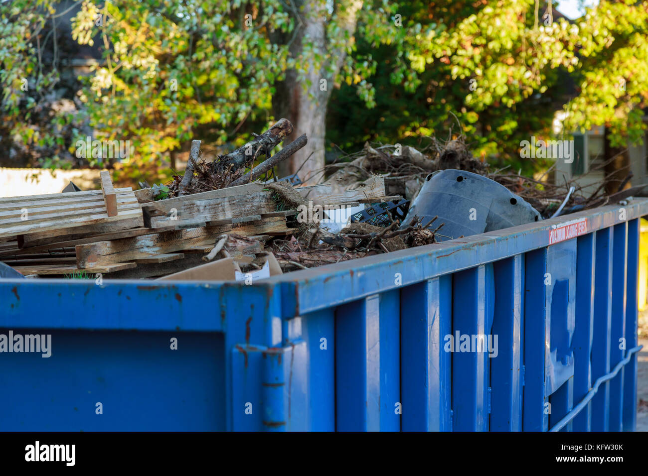 Industrial dumpster filled Loaded dumpster near a construction site ...
