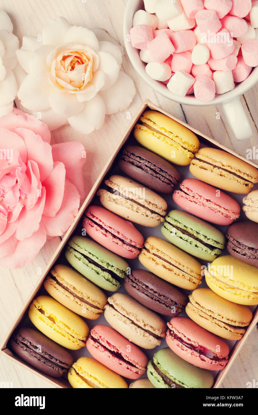 Colorful macaroons in a gift box and marshmallow in coffee cup on ...