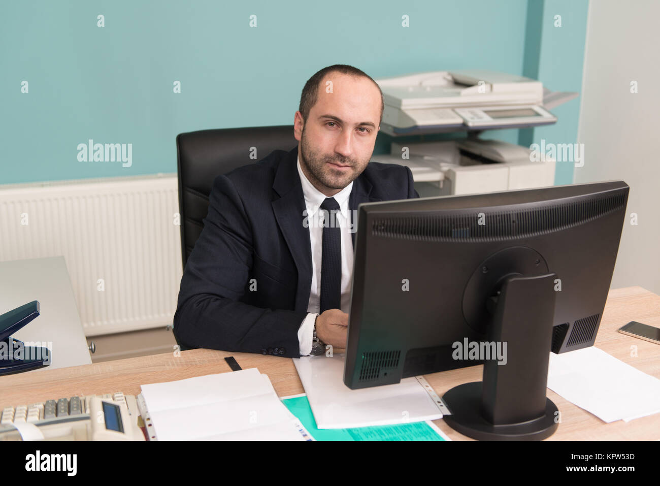 Portrait Of A Young Business Man Using A Computer In The Office Stock ...