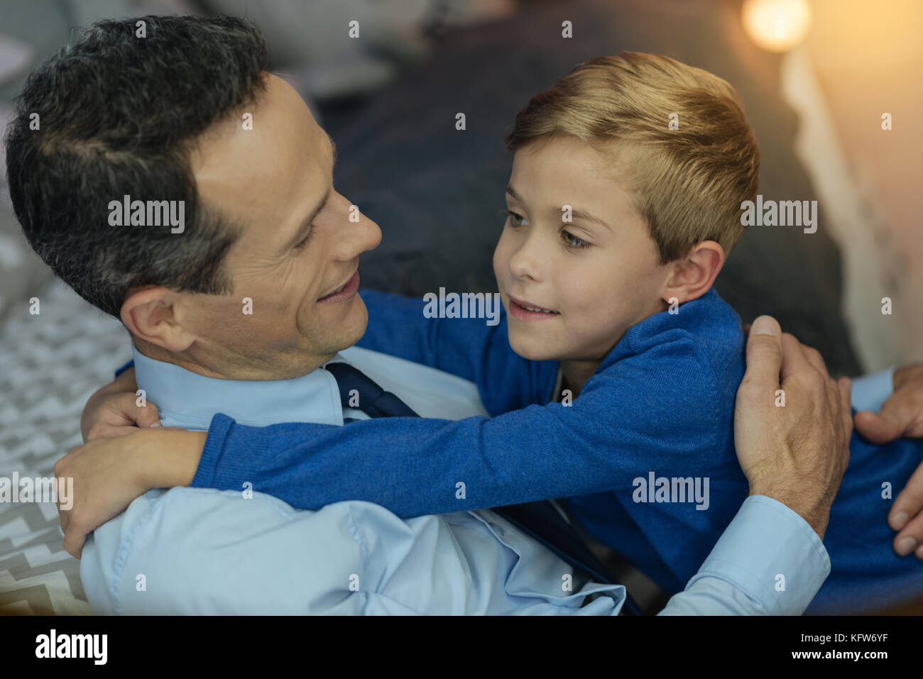 Positive father embracing his son Stock Photo - Alamy