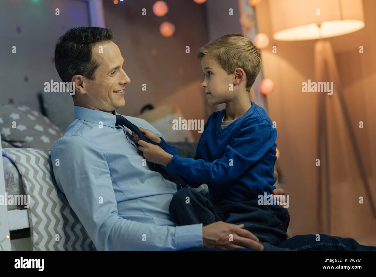 Pleased male person speaking with little boy Stock Photo - Alamy