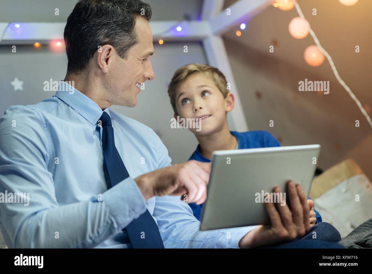 Surprised boy looking at his father Stock Photo - Alamy