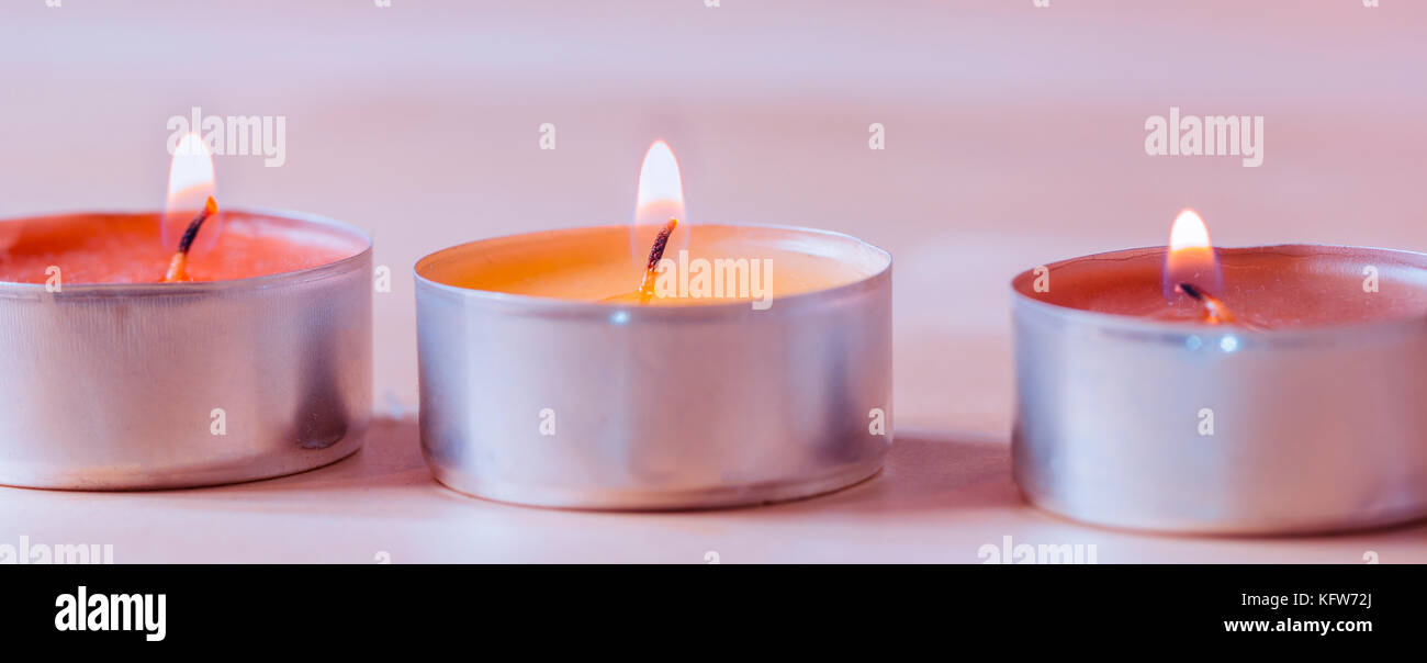 burning tea-lights with soft lights background Stock Photo - Alamy