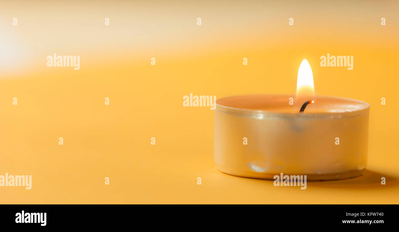 burning tea-lights with soft lights background Stock Photo - Alamy