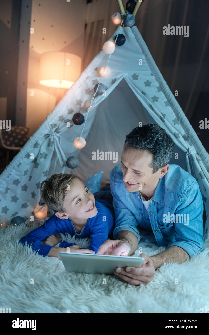 Positive man talking to his little kid Stock Photo - Alamy