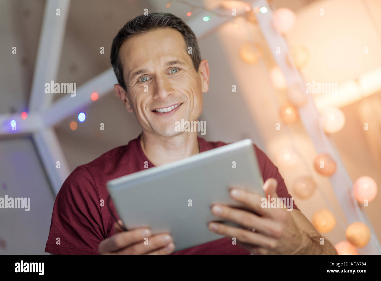 Delighted man keeping smile on his face Stock Photo - Alamy