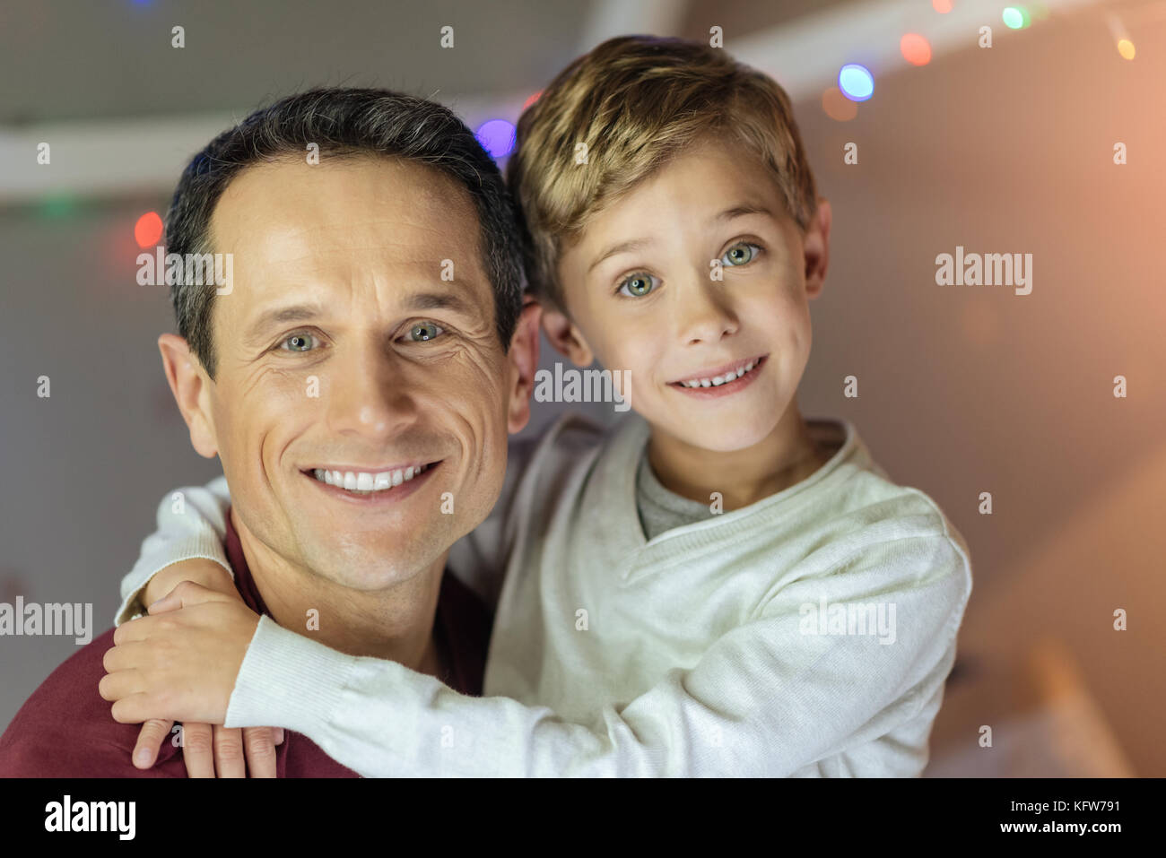 Positive boy embracing his father Stock Photo - Alamy