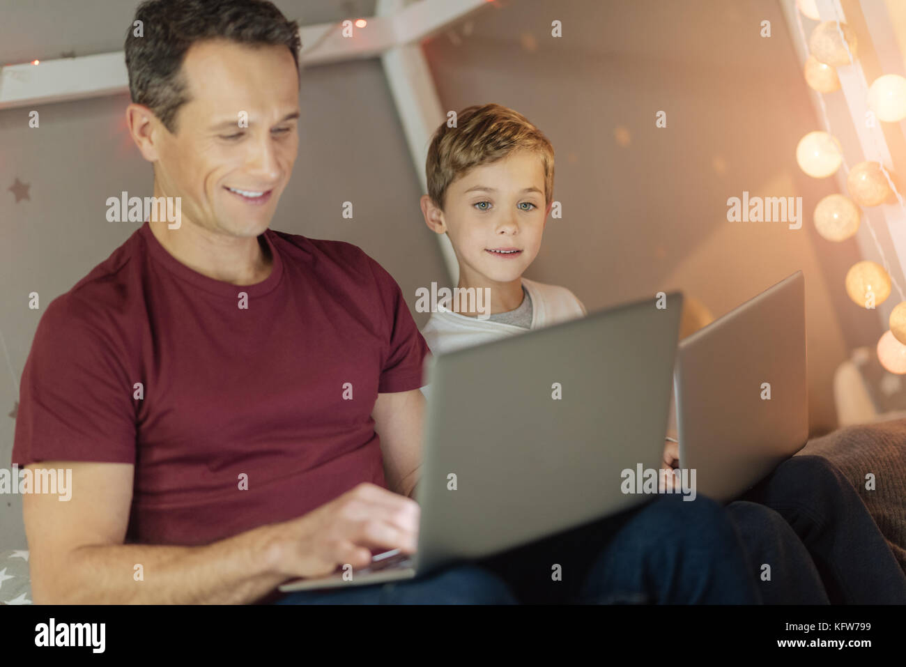 Attentive kid looking at screen of computer Stock Photo - Alamy