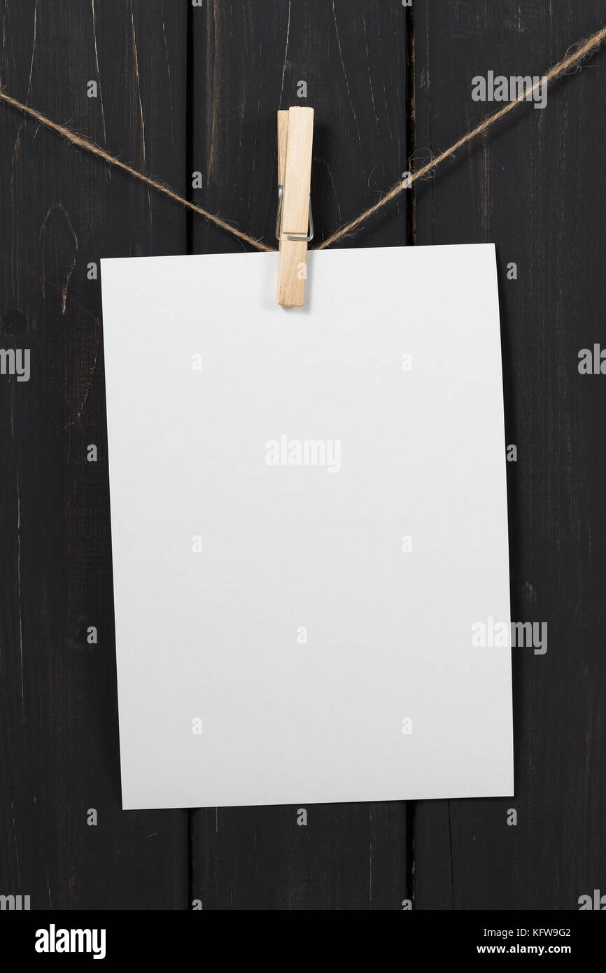 Blank white paper card hanging attach to rope with clothes pins on ...