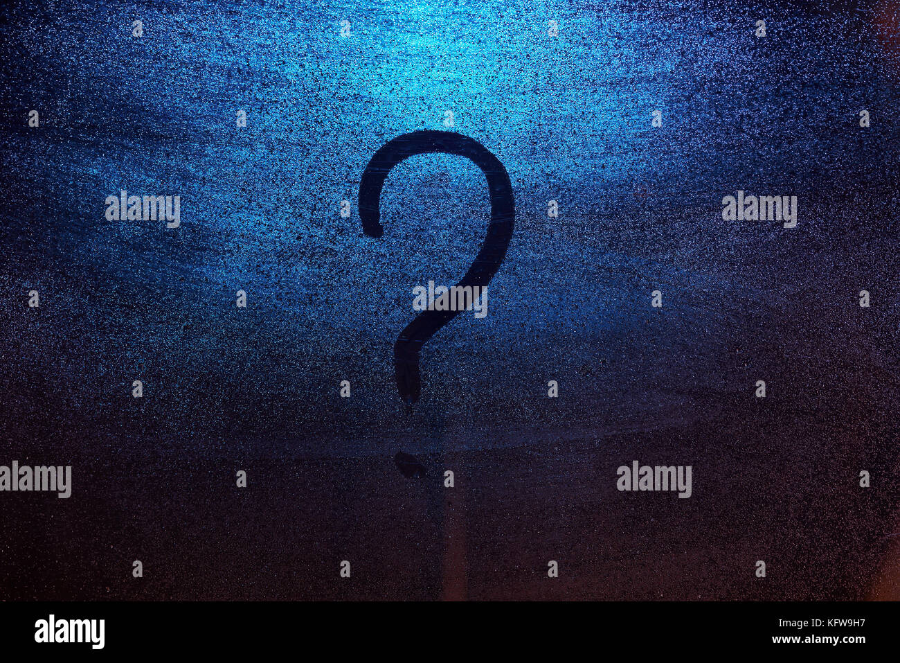 Question mark symbol draw on winter glass background. Close-up of ...