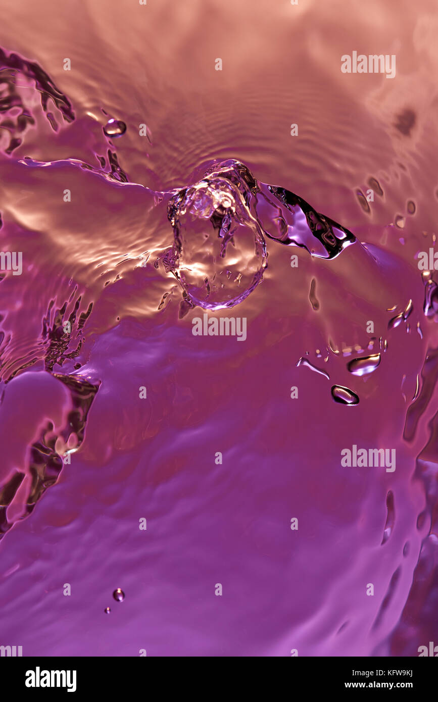 Closeup of colorful red water splash. Macro of rippled liquid texture ...