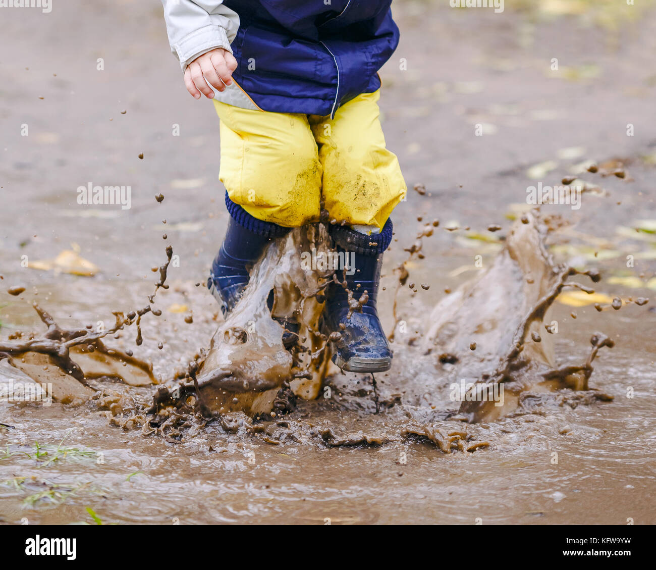 Child splash puddles boots hi-res stock photography and images - Alamy