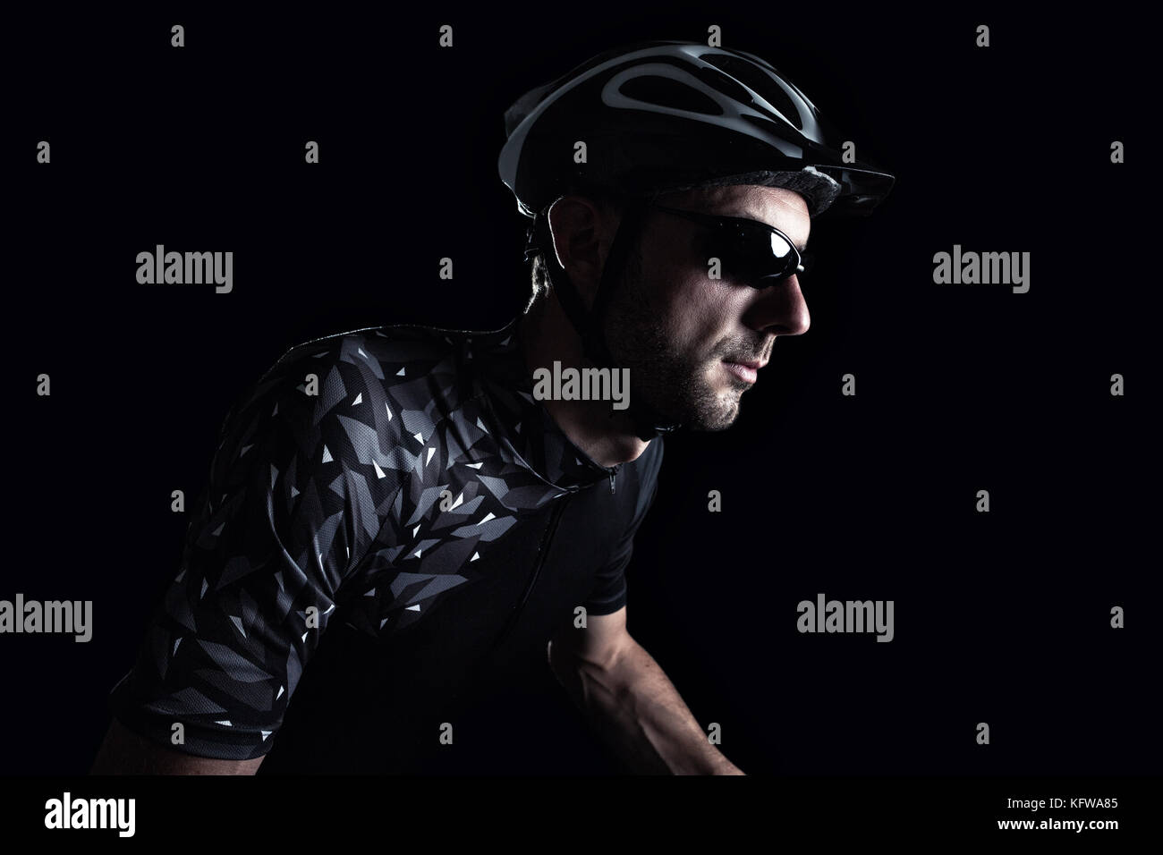 Cyclist with dark background Stock Photo - Alamy