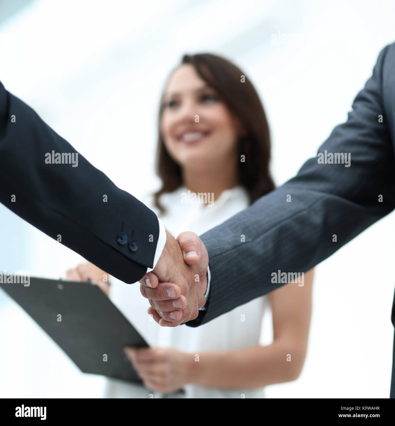 closeup.handshake of business people on the background of the workplace ...
