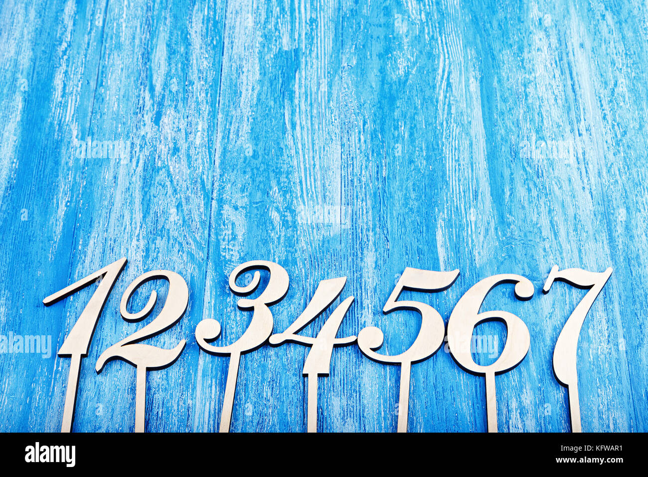 wooden numbers one, two, three, four, five, six, seven in a blue wooden ...