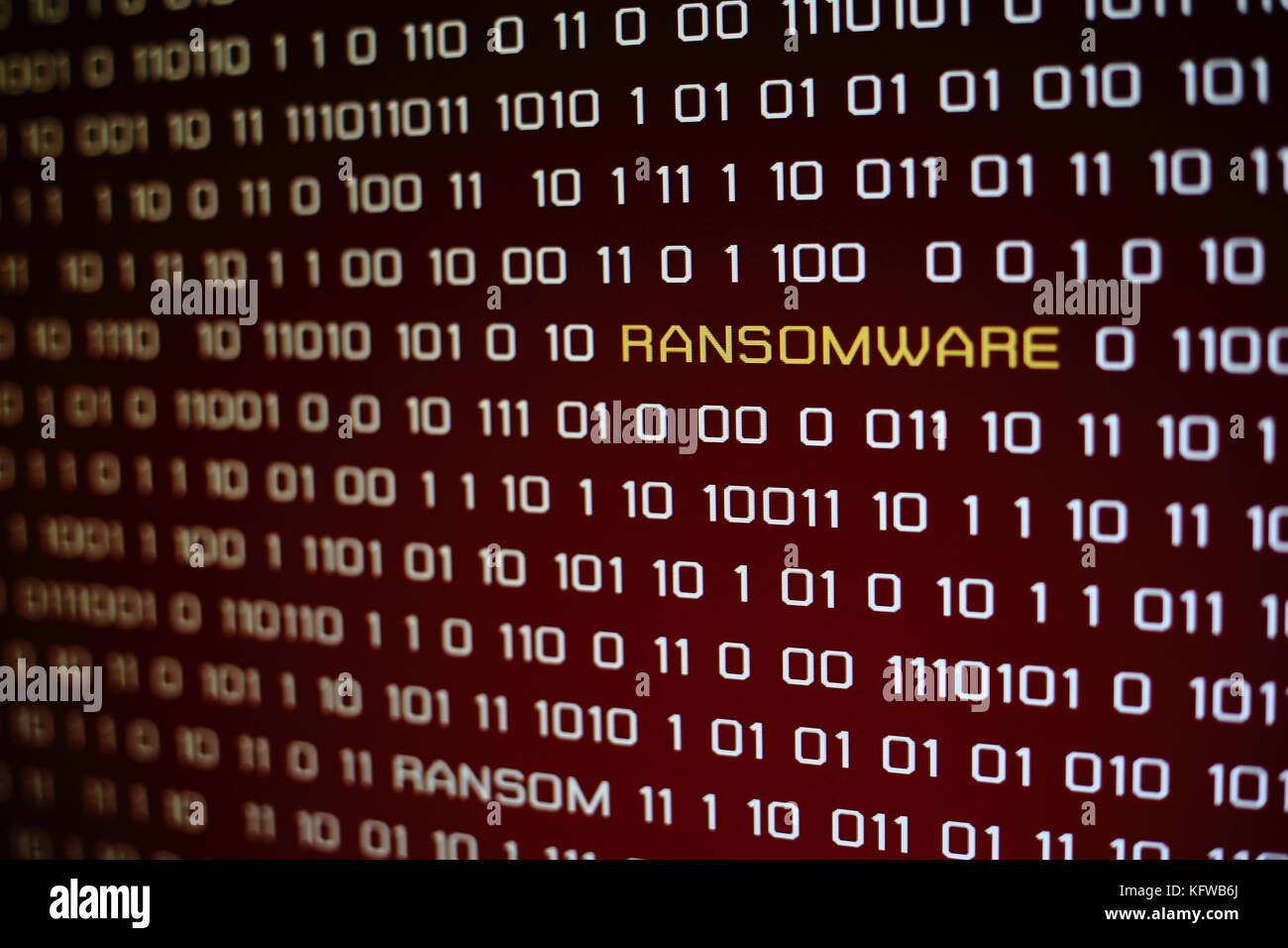 Hacked monitor. Ransomware. Binary digital numbers on red screen with ...