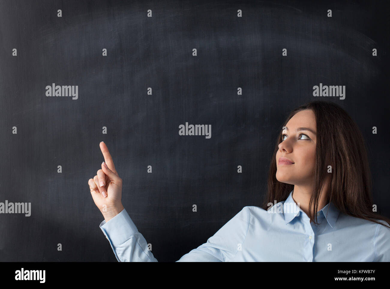 smiling businesswoman pointing at blackboard Stock Photo - Alamy