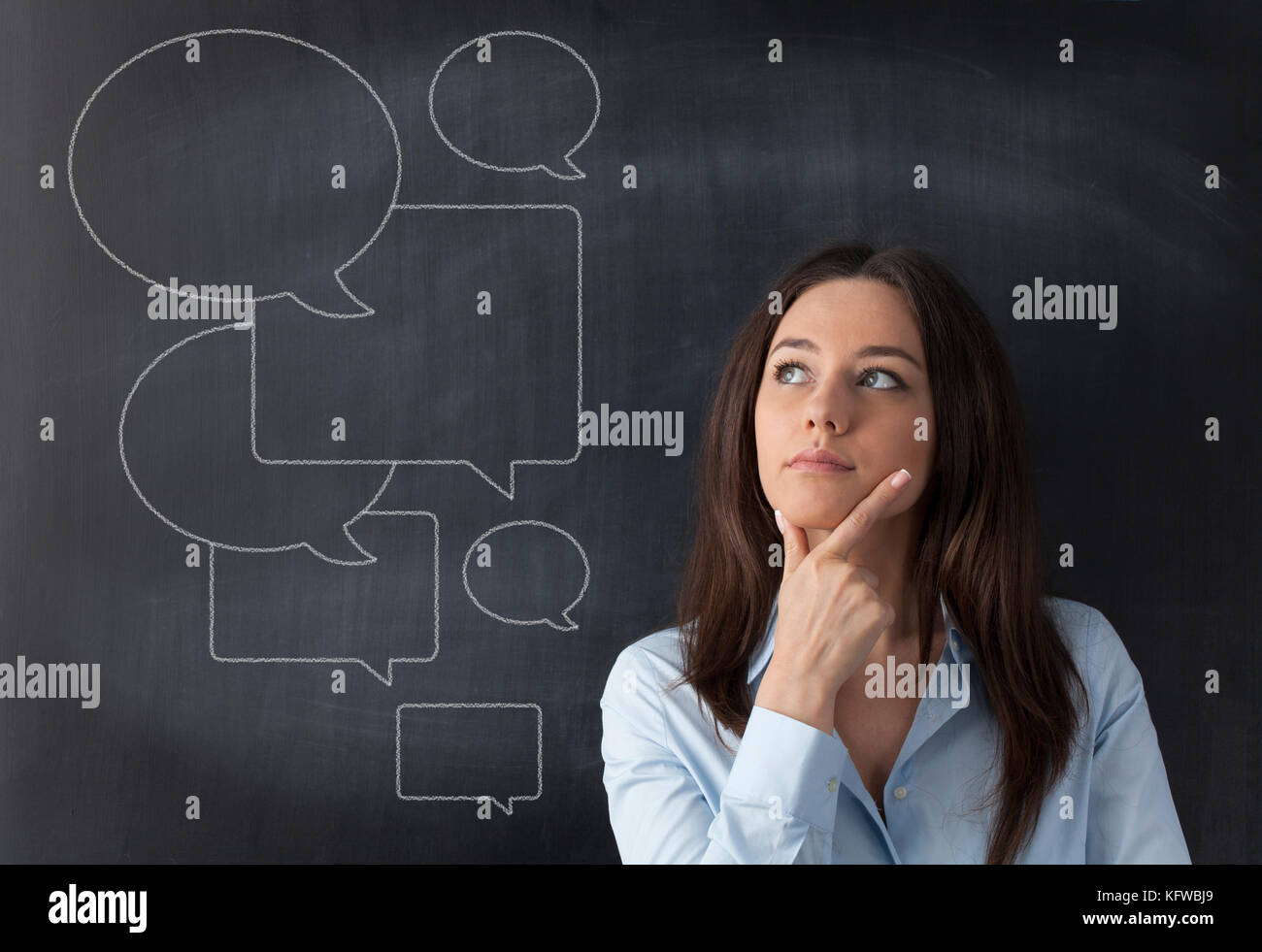 Businesswoman thinking with talking bubbles on blackboard Stock Photo ...