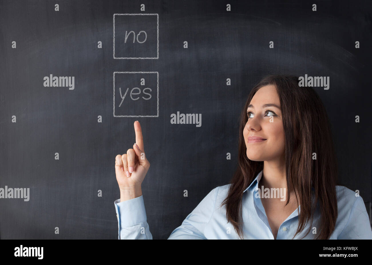 Smiling business woman to point into a 'yes' written text on the ...