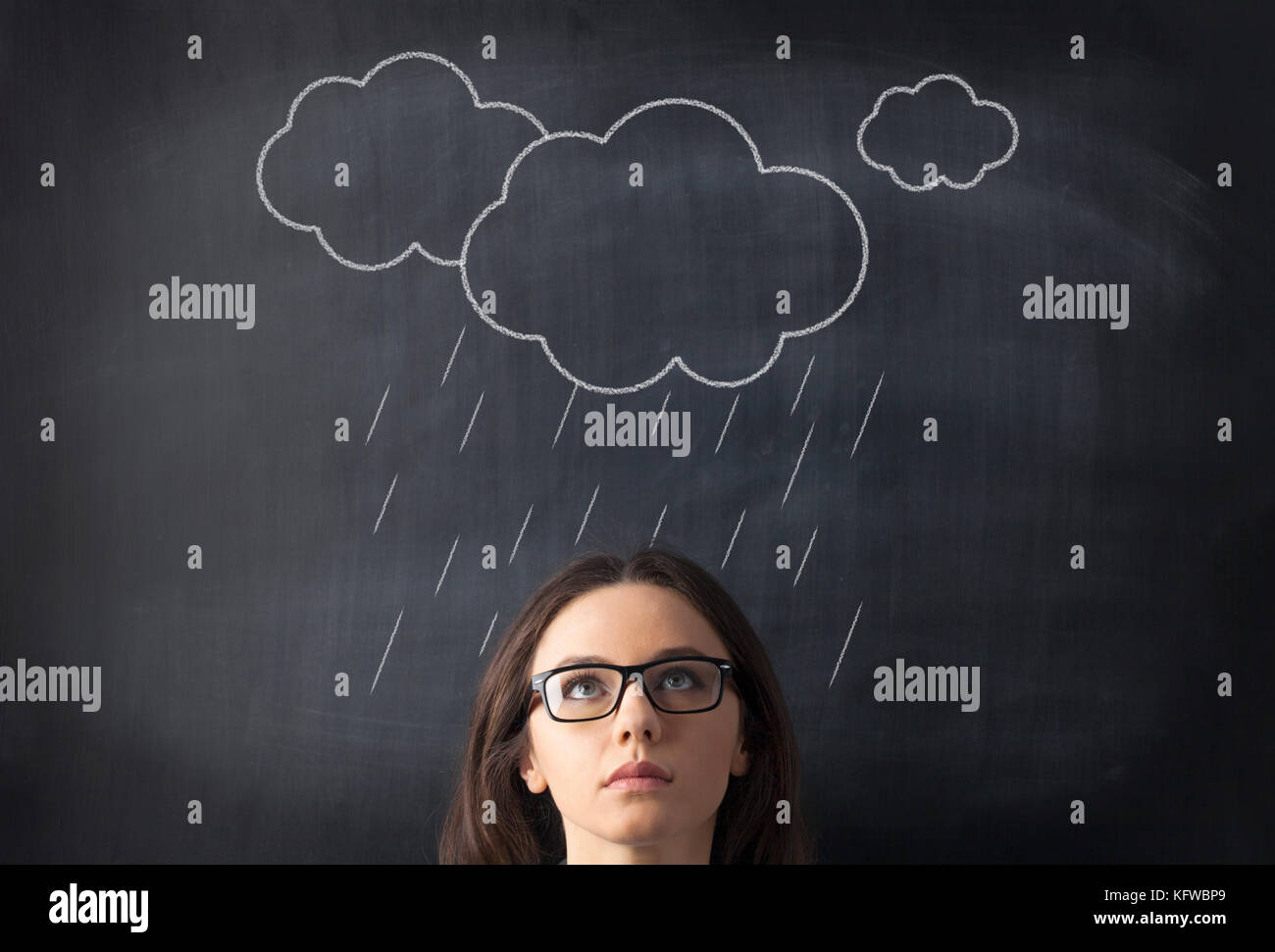Young woman in bad mood with clouds and rain above head Stock Photo - Alamy