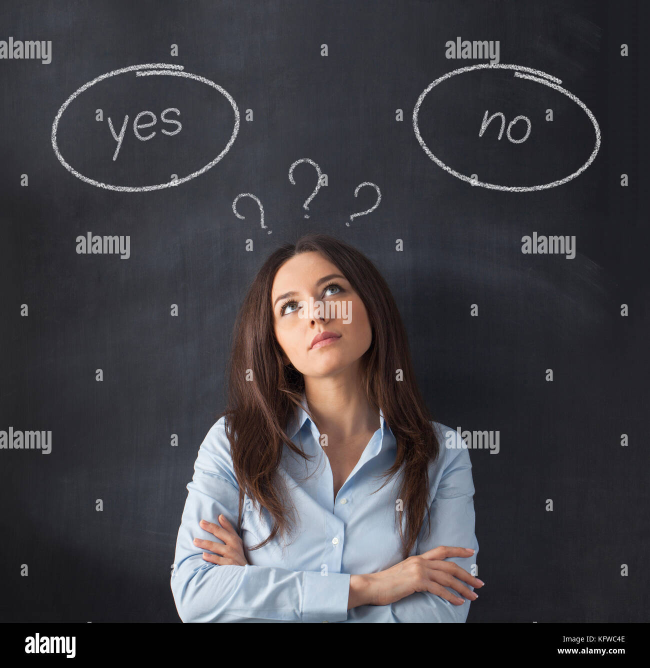 Businesswoman is standing on blackboard background and thinking: yes or ...