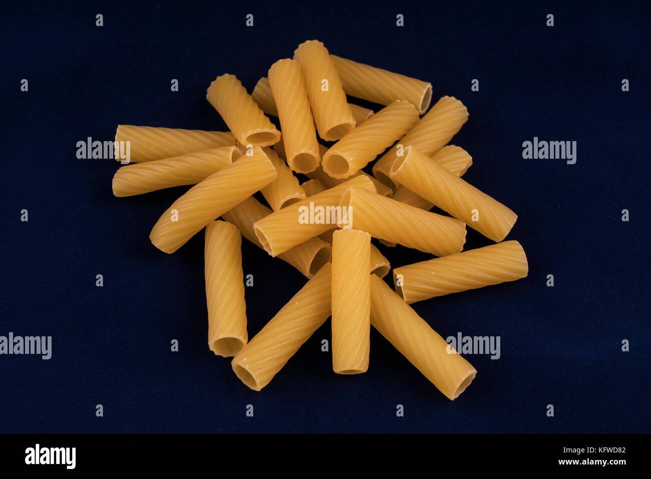 Italian rigatoni pasta on a blue background Stock Photo - Alamy