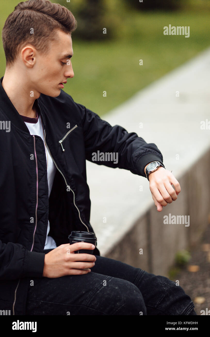 Young boy look at his watch and smile Stock Photo - Alamy