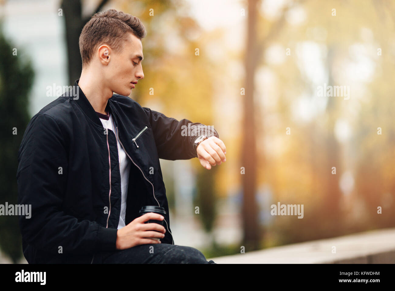 Young boy look at his watch and smile Stock Photo - Alamy