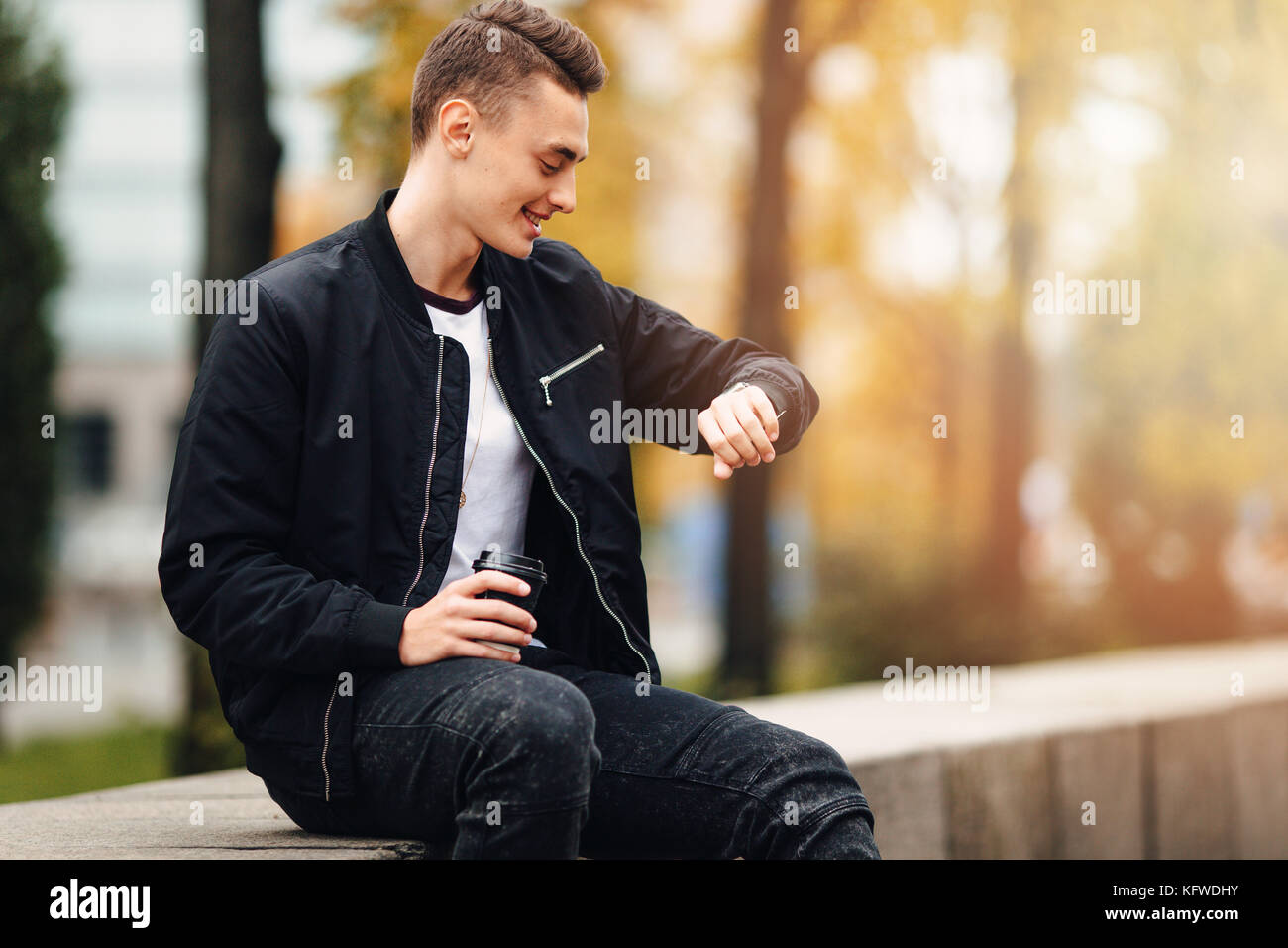 Young boy look at his watch and smile Stock Photo - Alamy