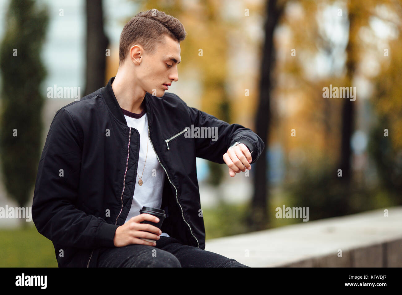 Young boy look at his watch and smile Stock Photo - Alamy