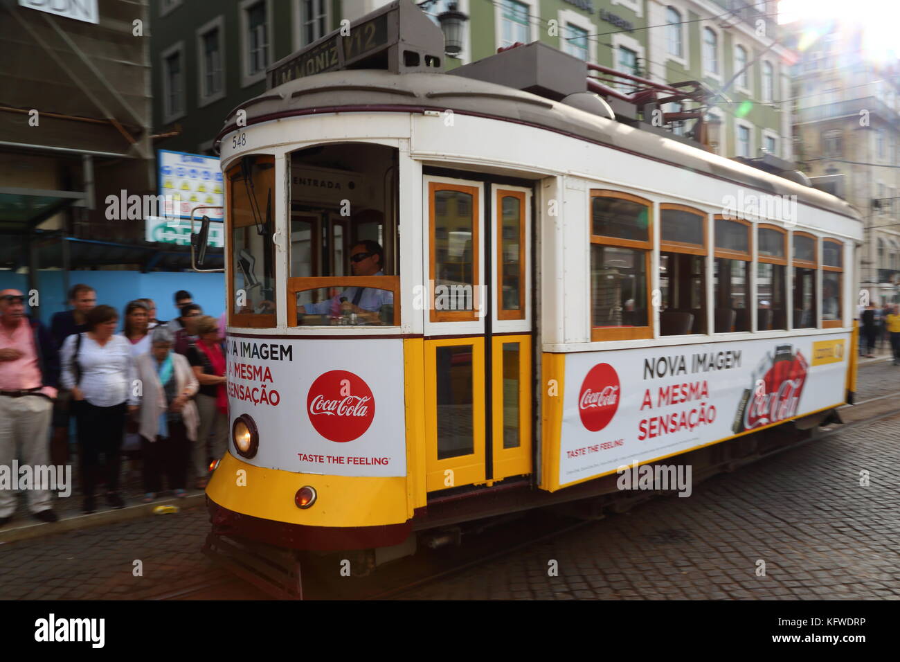 Passengers boarding a traditional tram in Lisbon, Portugal Stock Photo ...