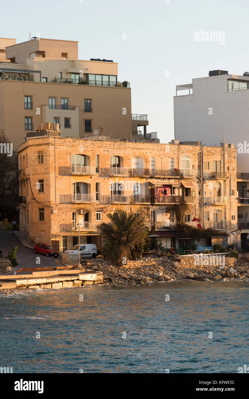 An old stone apartment building at St Julians Bay Malta in early ...