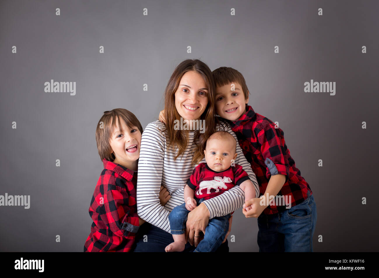 Family christmas portrait, mother with her three sons, isolated on gray, studio image Stock ...
