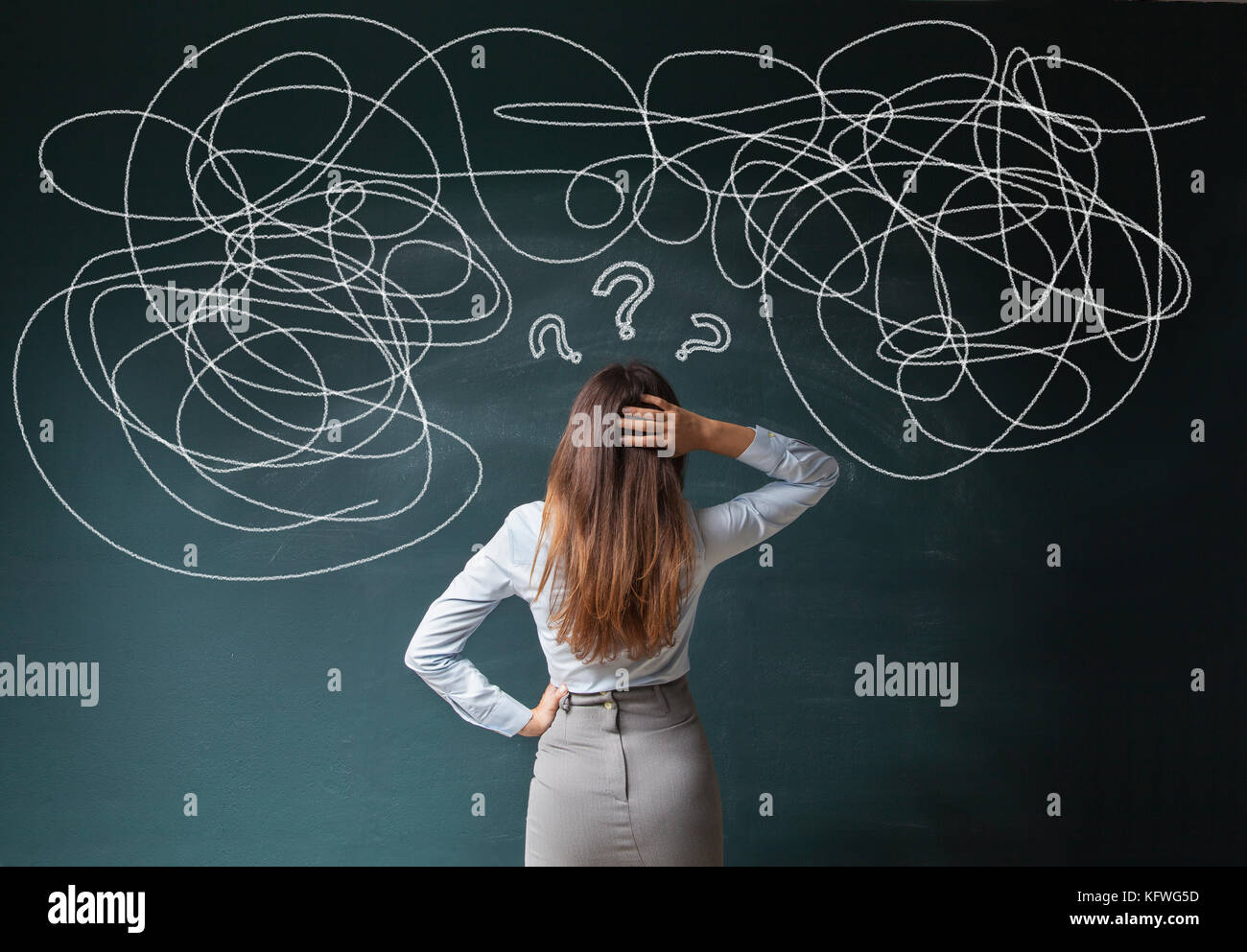 Confused business woman staring at scribble on blackboard Stock Photo ...