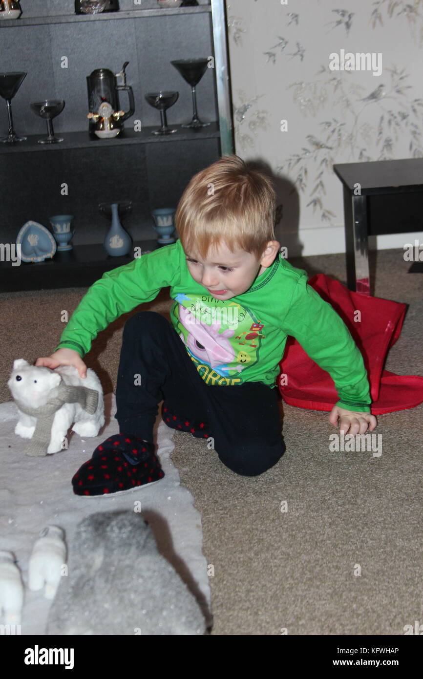 A child opening Christmas presents on Christmas morning Stock Photo - Alamy