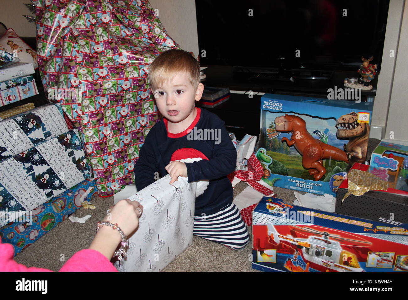 A child opening Christmas presents on Christmas morning Stock Photo - Alamy