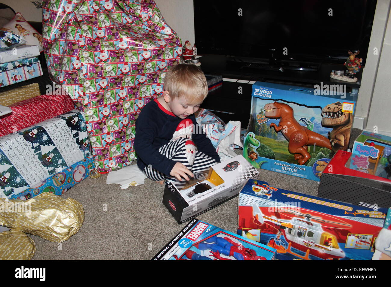 A child opening Christmas presents on Christmas morning Stock Photo - Alamy