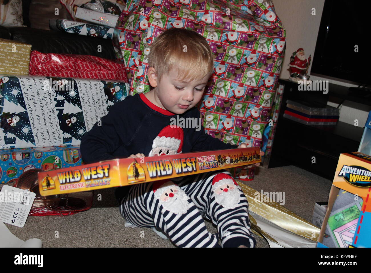 A child opening Christmas presents on Christmas morning Stock Photo - Alamy