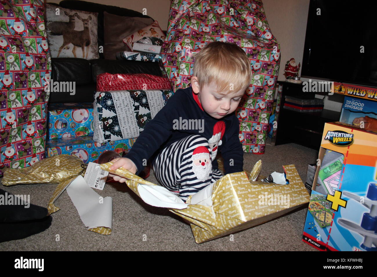 A child opening Christmas presents on Christmas morning Stock Photo - Alamy