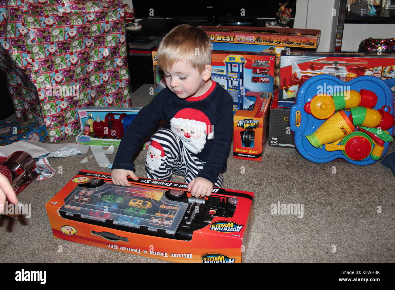 A child opening Christmas presents on Christmas morning Stock Photo - Alamy