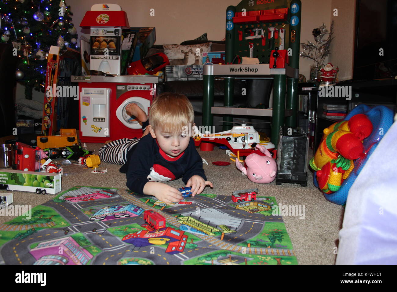 A child opening Christmas presents on Christmas morning Stock Photo - Alamy