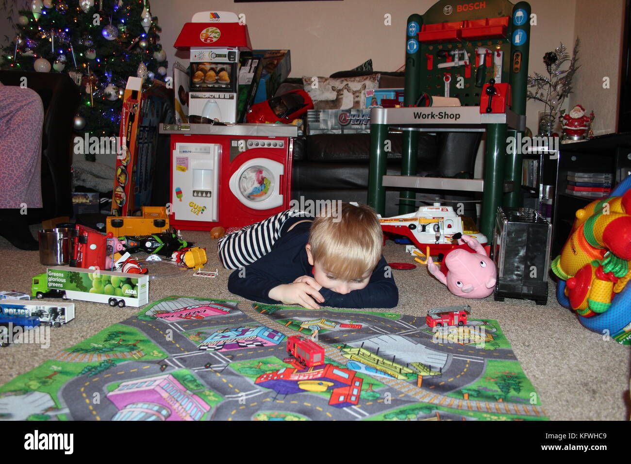 A child opening Christmas presents on Christmas morning Stock Photo - Alamy