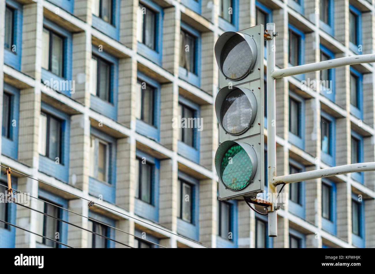 Green Traffic Light in the city against the background of multi-storey ...