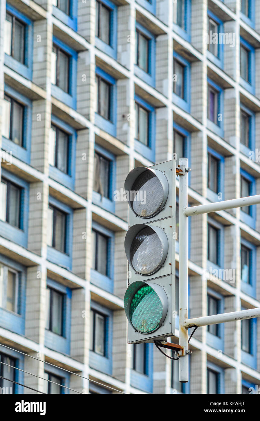 Green Traffic Light in the city against the background of multi-storey ...
