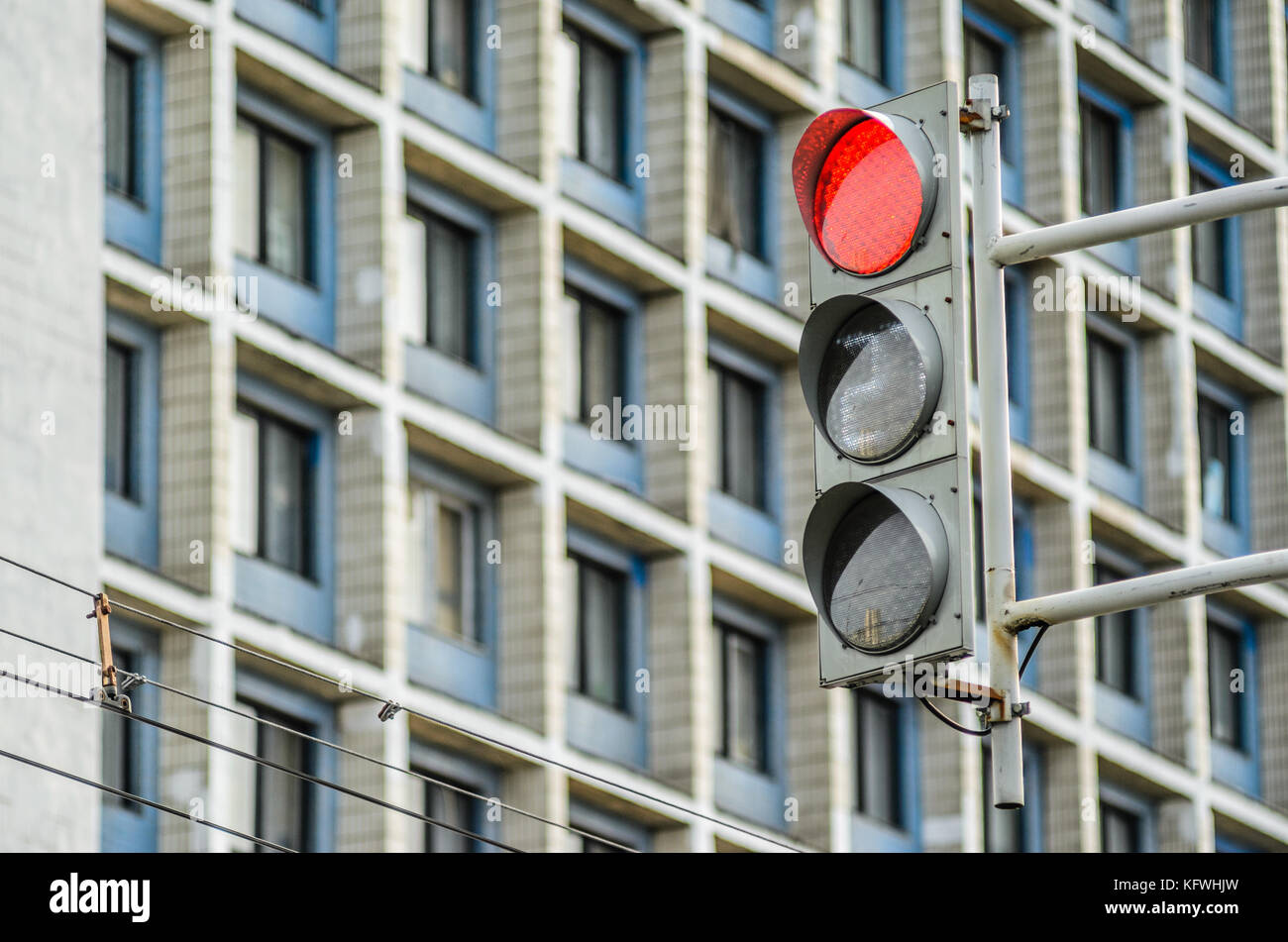 A traffic light against the background of multi-storey apartment ...