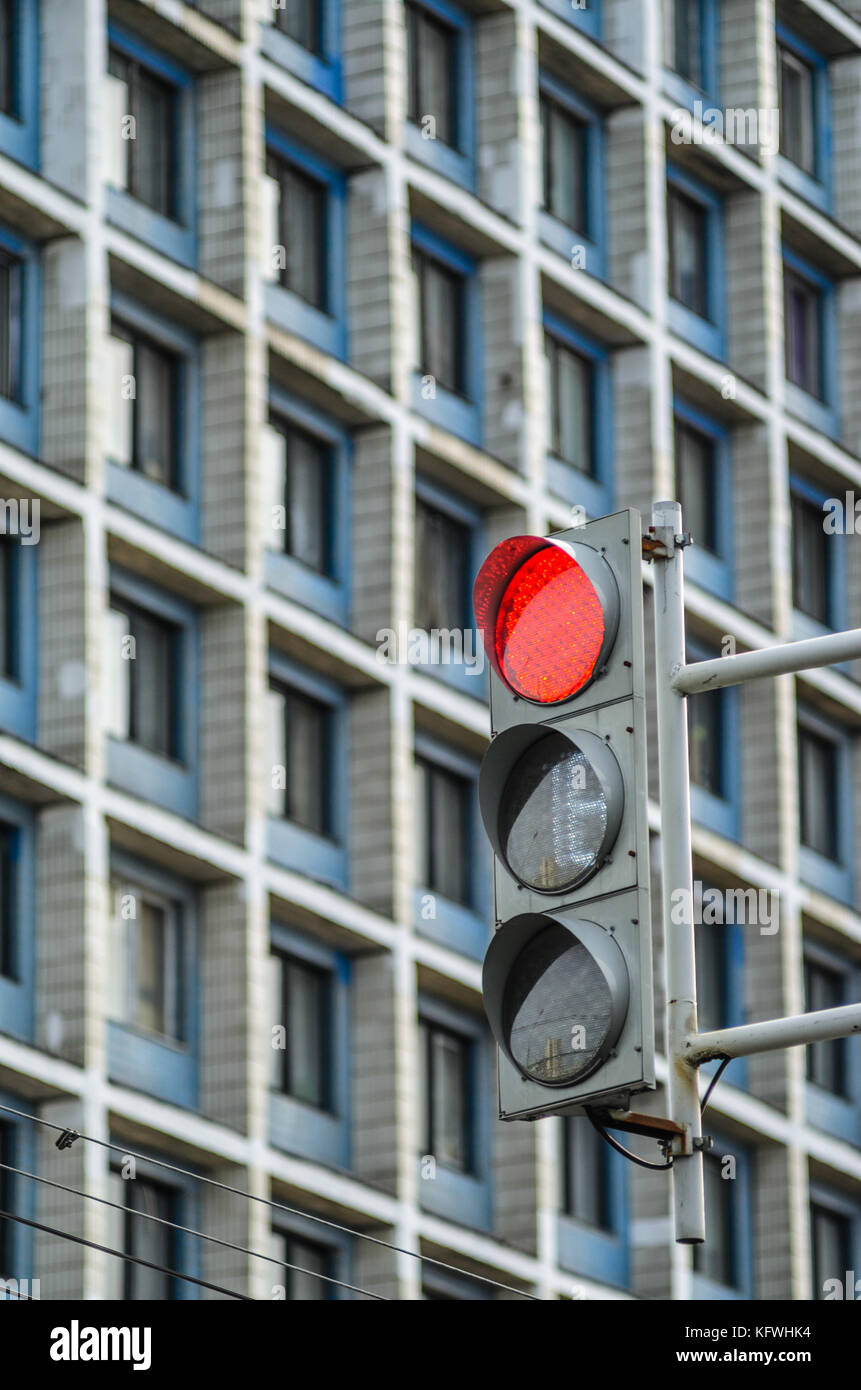 A traffic light against the background of multi-storey apartment ...